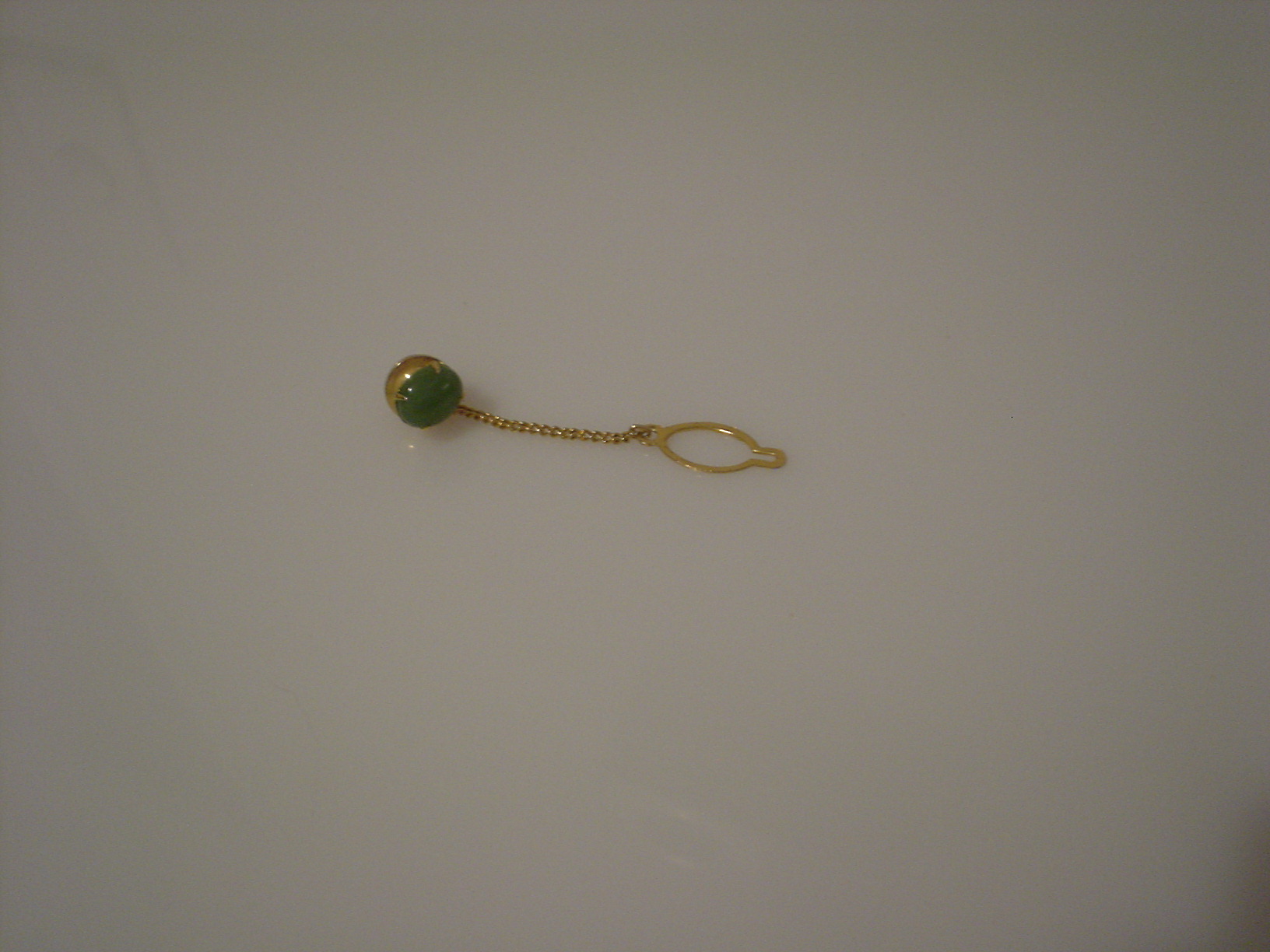 Green oval tie tack